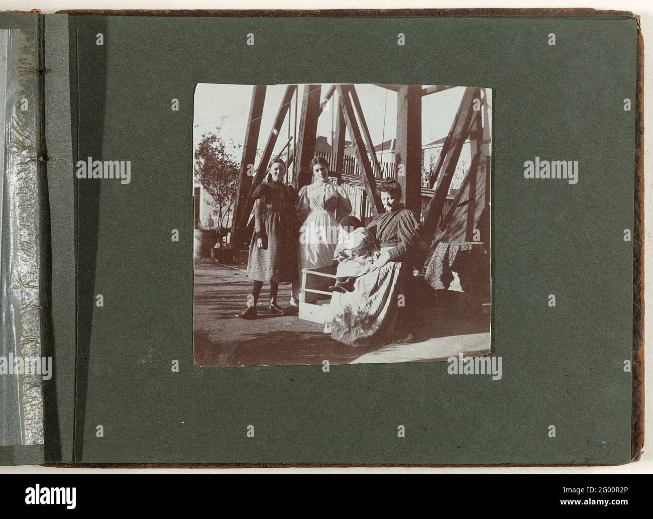 Woman, two girls and a child at the foot of a derrick (?), Pleasure ...