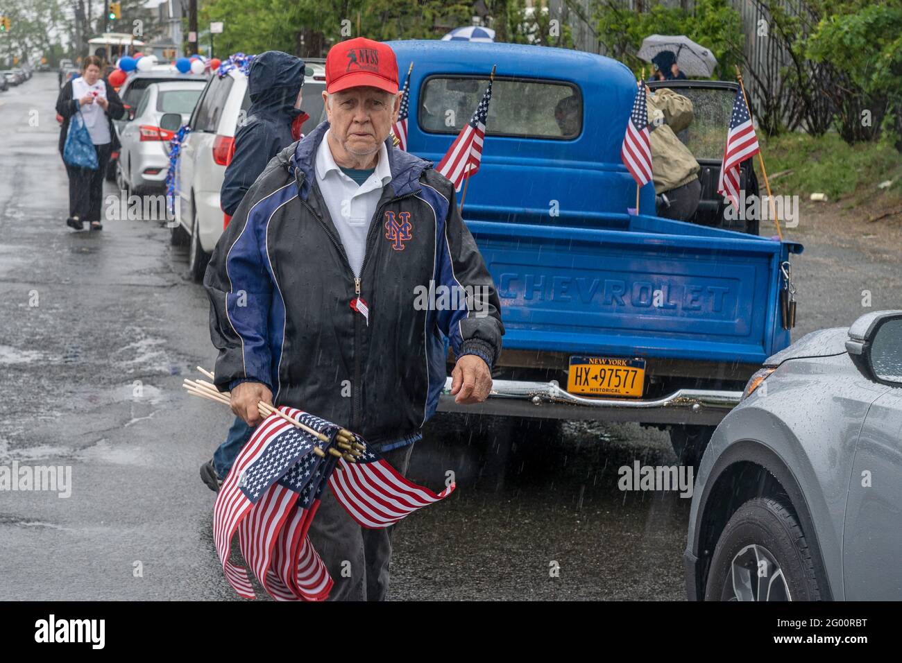 NEW YORK, NY - MAY 30: An organizer hands out American flags to ...