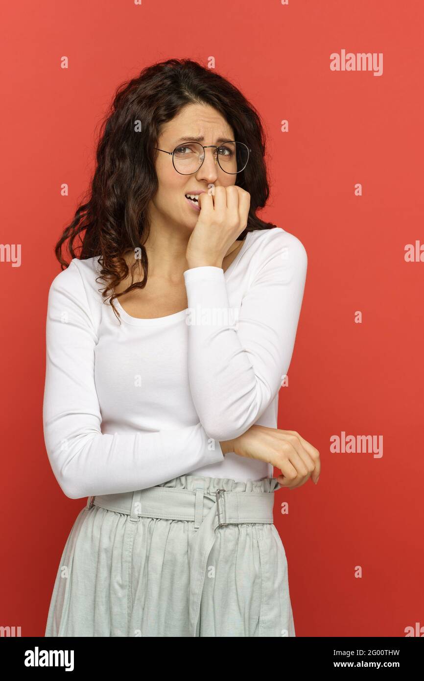 Anxious young female scared nervous bite nails in anxiety look in ...