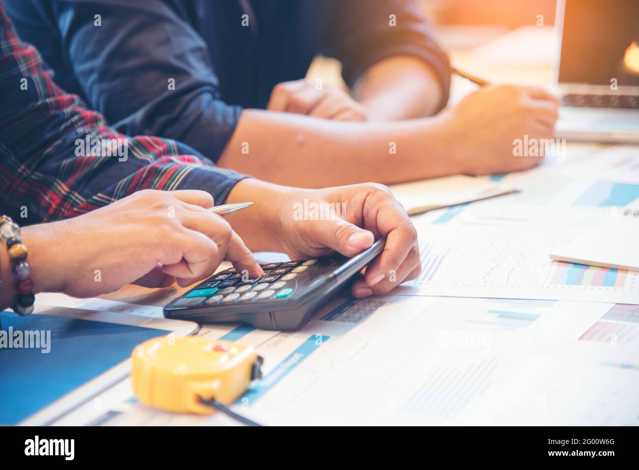 Businessman and building contractor are discussion using calculator to ...