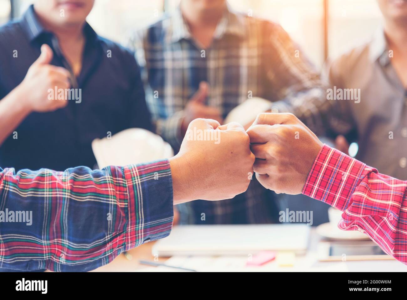 Team Business Partners Giving Fist Bump after complete a deal ...