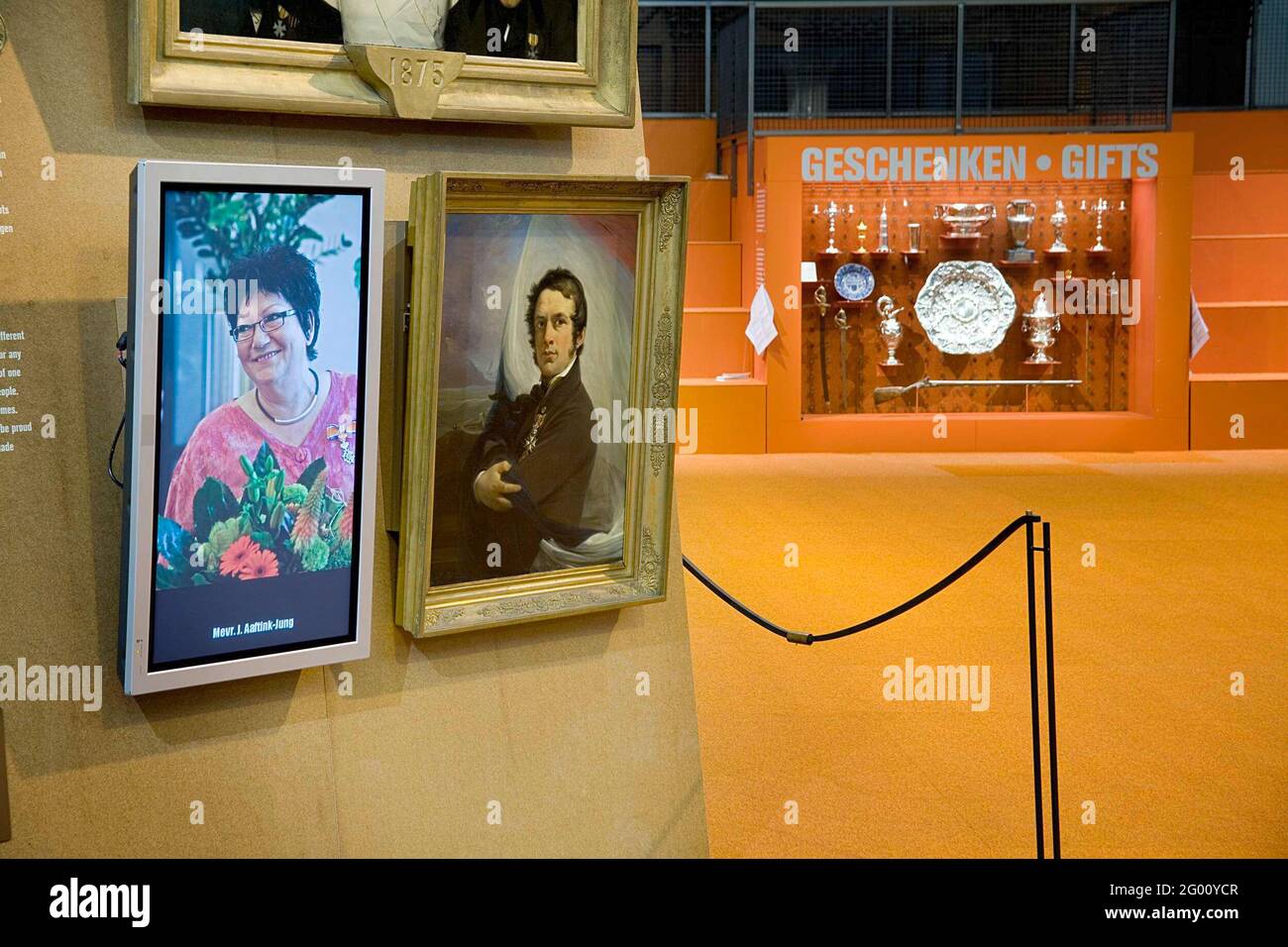 Screen on which a woman can be seen, in addition a painted portrait of ...