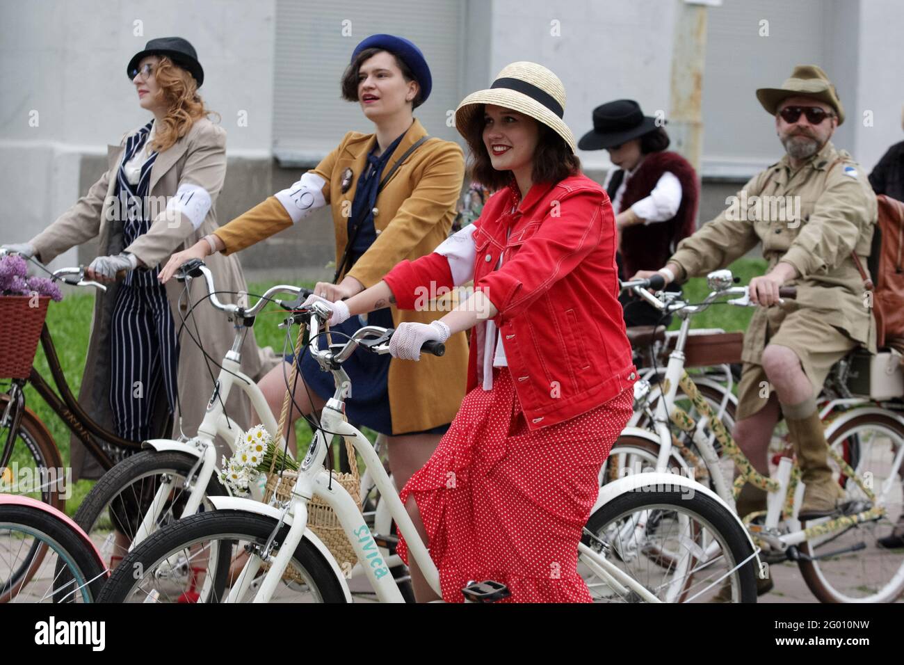 Participants wearing vintage outfits take part during a retro cycle ...