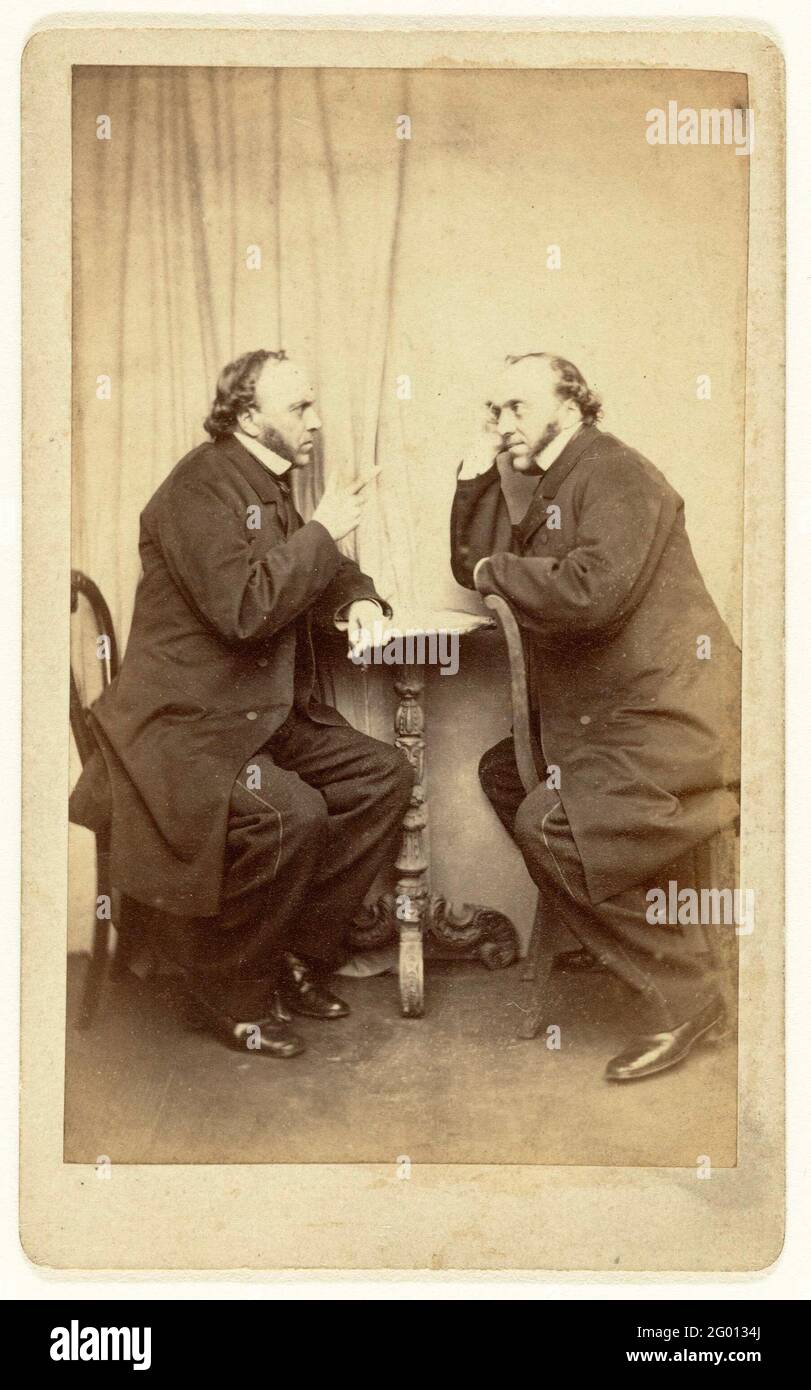Portrait two men at the table sitting, acting conversation Stock Photo ...