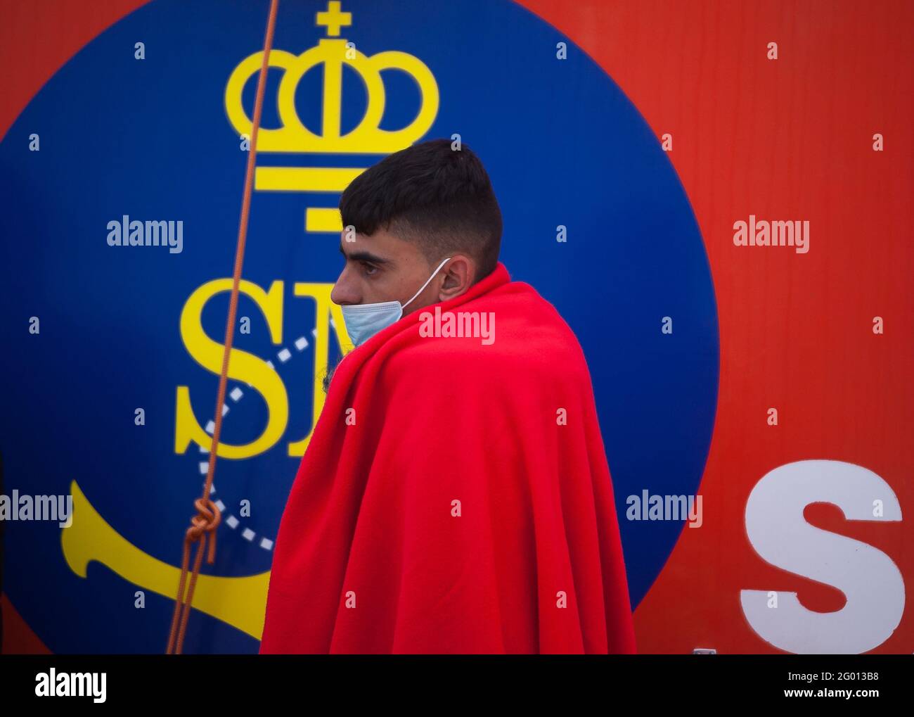 A migrant waiting to disembark from a rescue boat, during their arrival ...