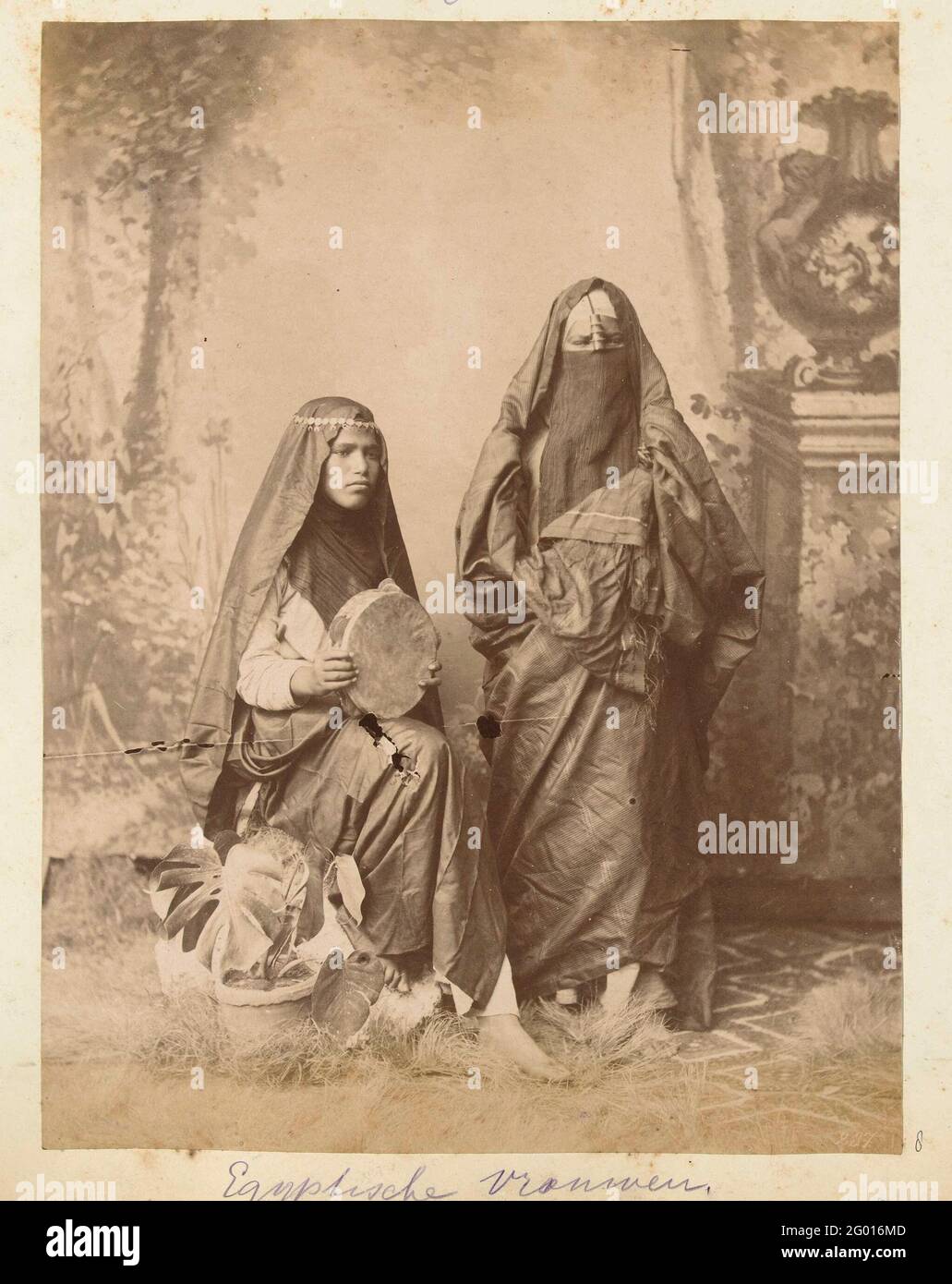Studio portrait of two veiled women; Egyptian women. The left woman has ...