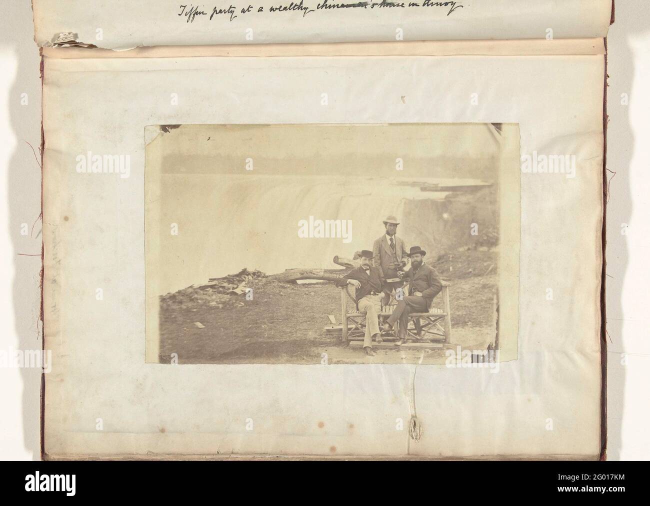 Portrait of three men on a bench against the background of a waterfall ...