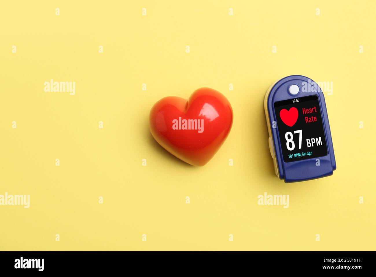 Red heart and pulse oximeter on color background Stock Photo - Alamy
