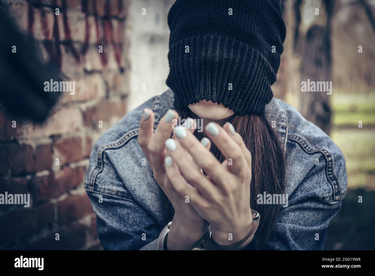 Female hostage in handcuffs outdoors Stock Photo - Alamy
