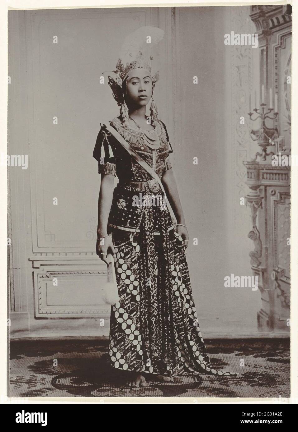 Portrait of a Javanese woman with a range in hand and a crown on the ...