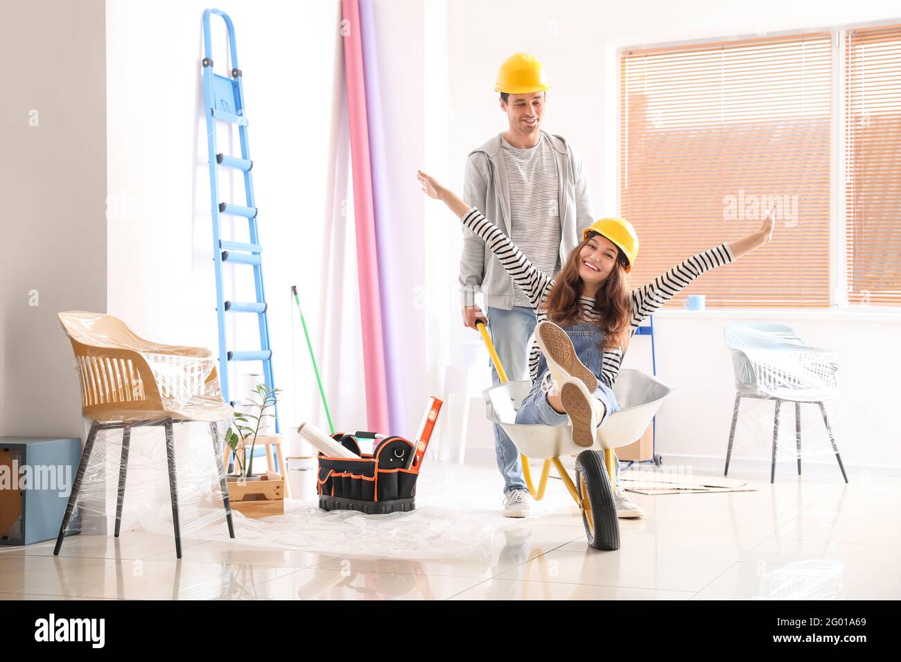 Happy young couple having fun during repair in their new house Stock ...