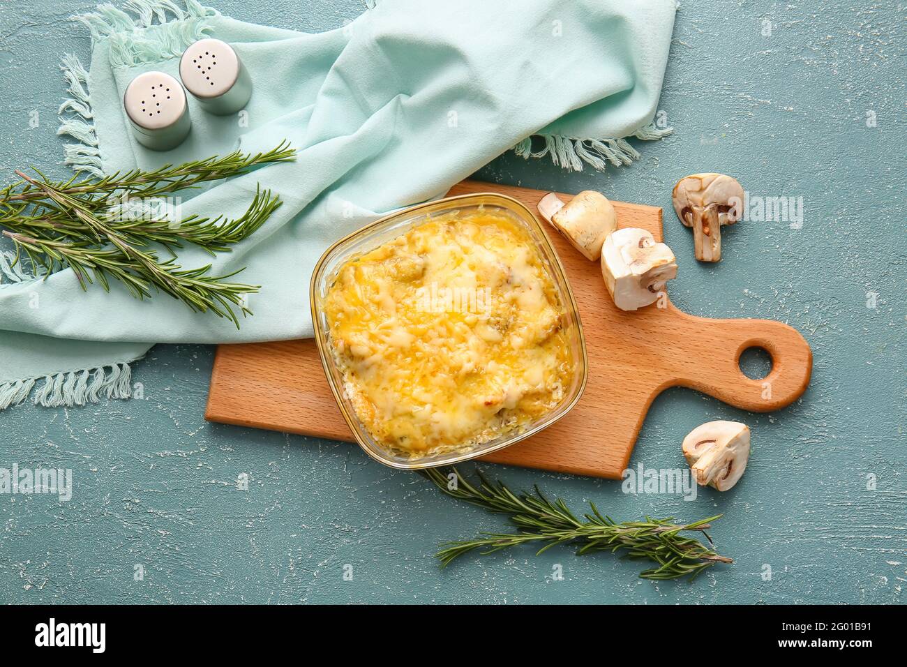 Baking dish with tasty julienne and ingredients on color background ...