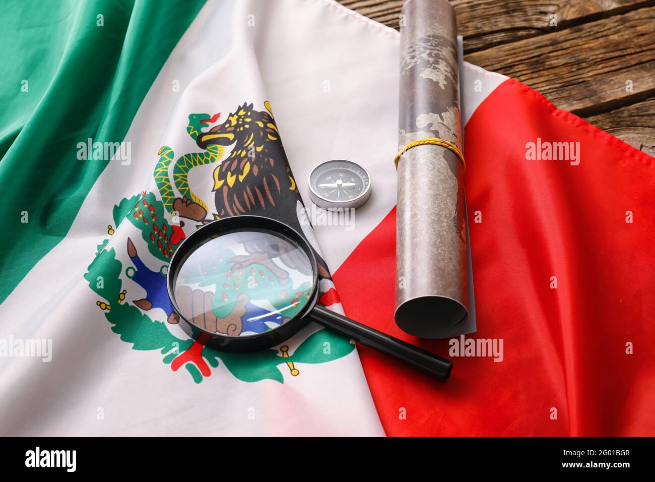 Mexican flag, compass, world map and magnifier on wooden background ...