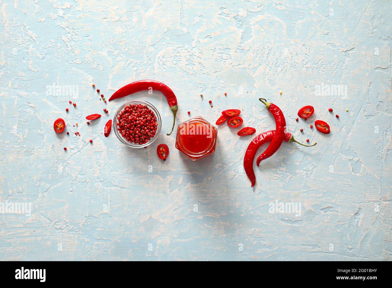 Composition with tasty chili sauce and ingredients on color background ...