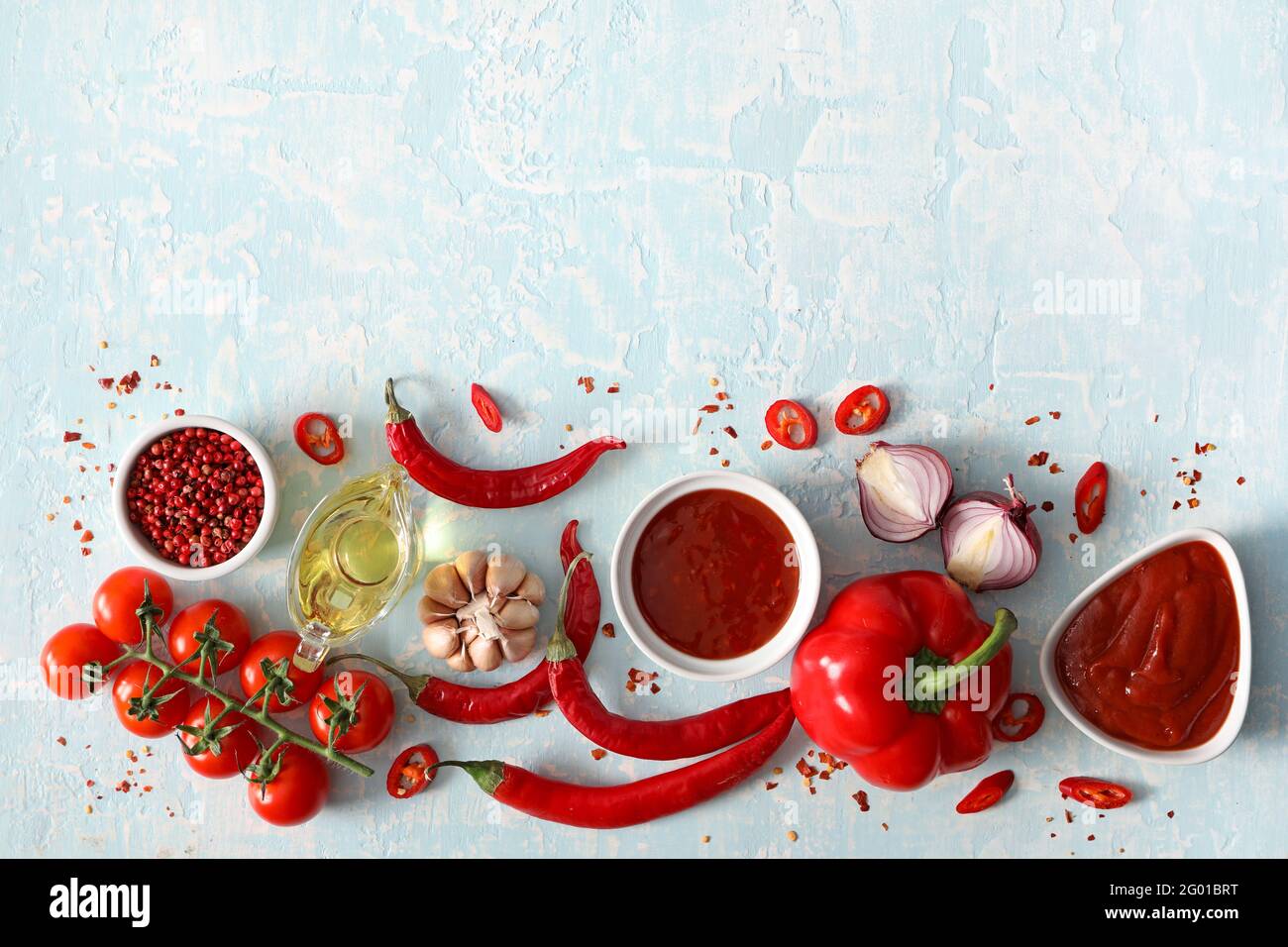 Composition with tasty chili sauce and ingredients on color background ...