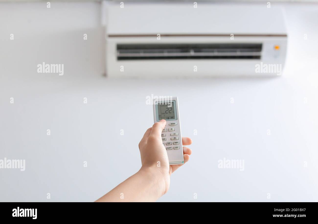 Female hand with air conditioner remote control indoors, closeup Stock ...