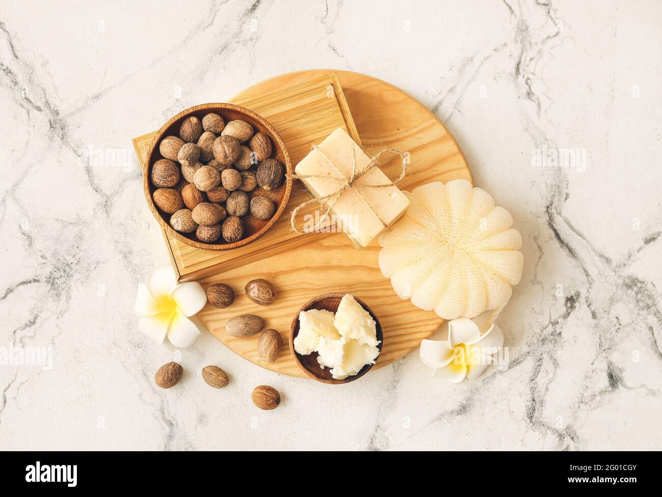 Shea butter, nuts and bath supplies on light background Stock Photo - Alamy