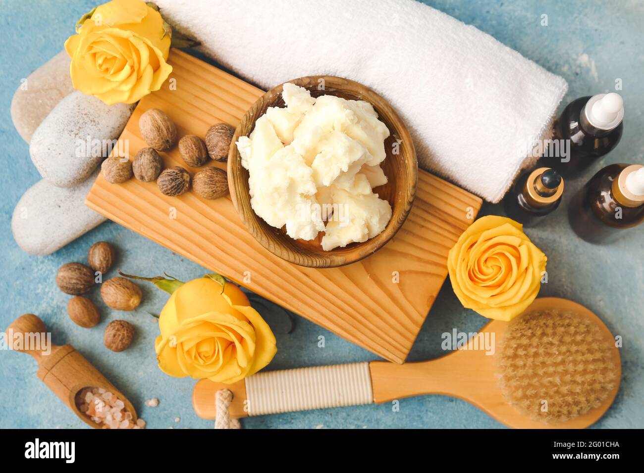 Composition with shea butter, bath supplies and flowers on color ...