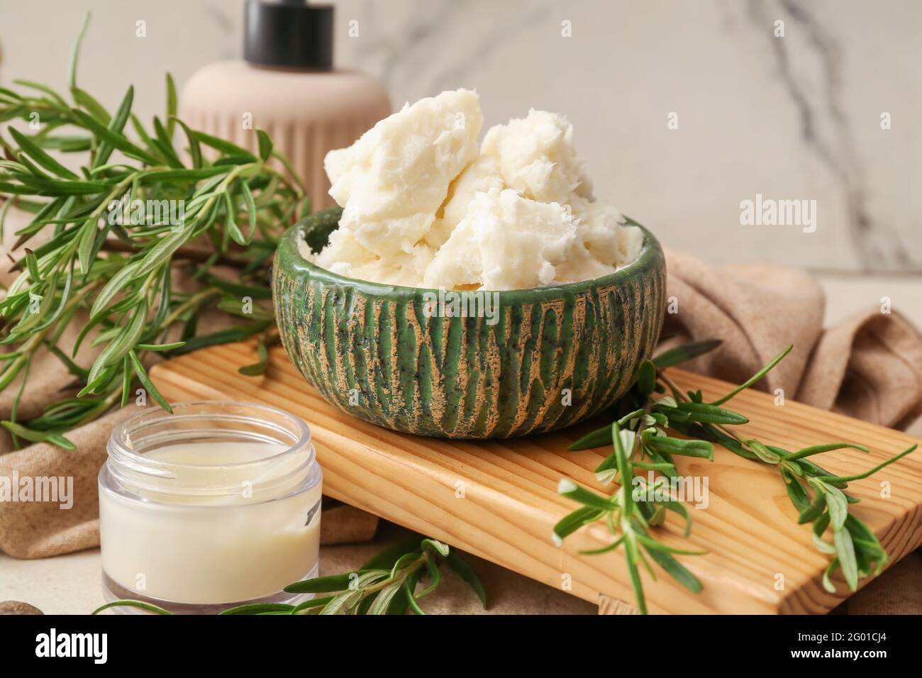 Composition with shea butter and herbs on light background Stock Photo ...