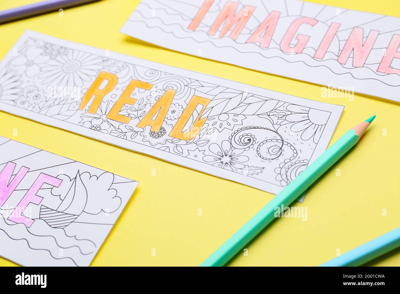 Cute bookmarks with pencils on color background Stock Photo - Alamy