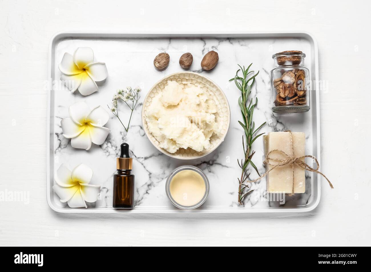 Composition with shea butter and cosmetic products on light background ...