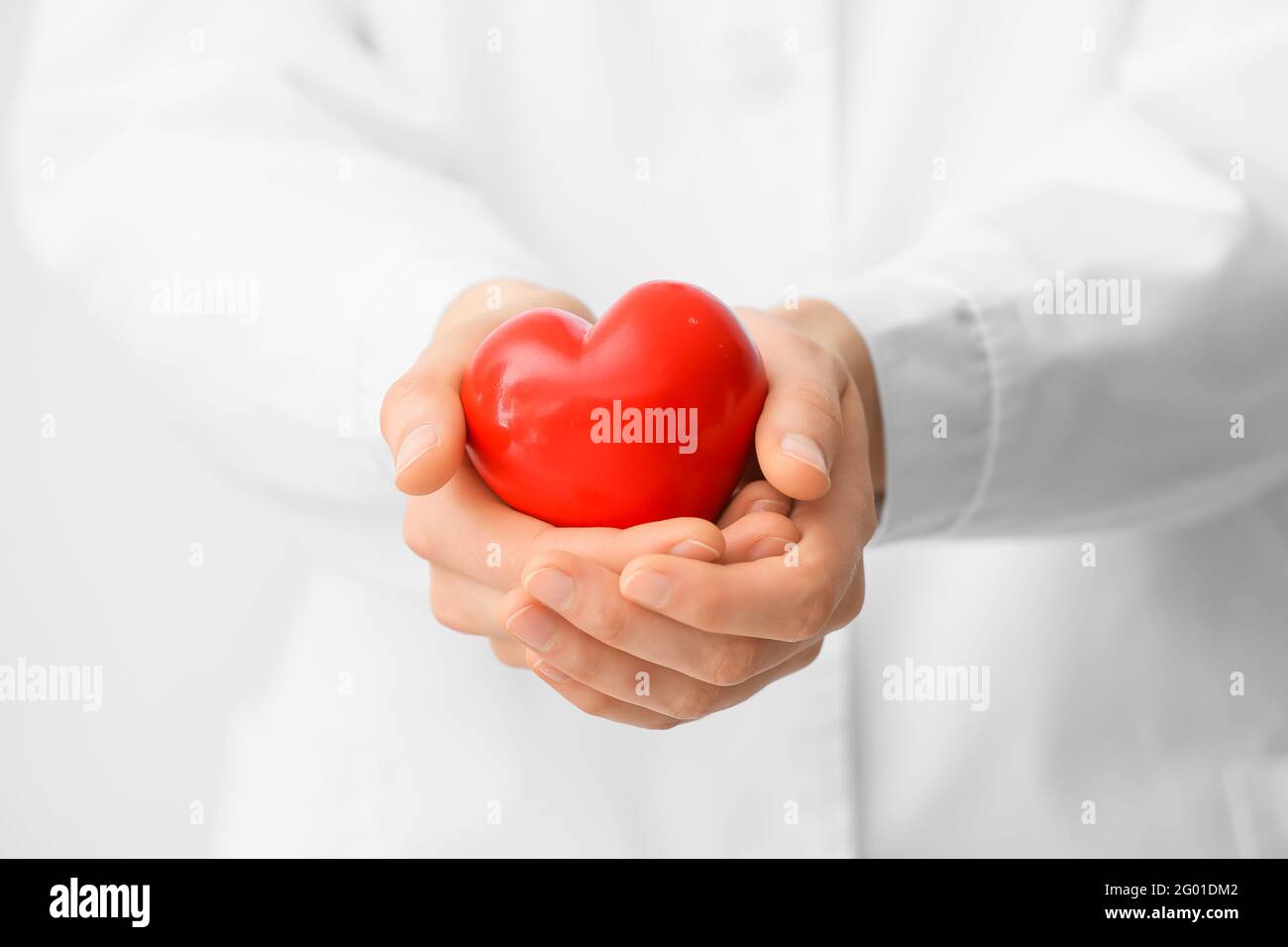 Doctor with red heart, closeup Stock Photo - Alamy