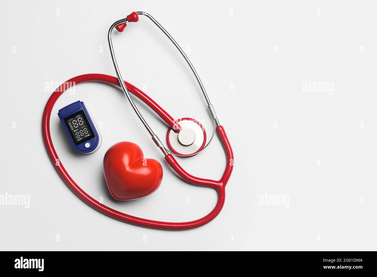 Red heart with pulse oximeter and stethoscope on white background Stock ...