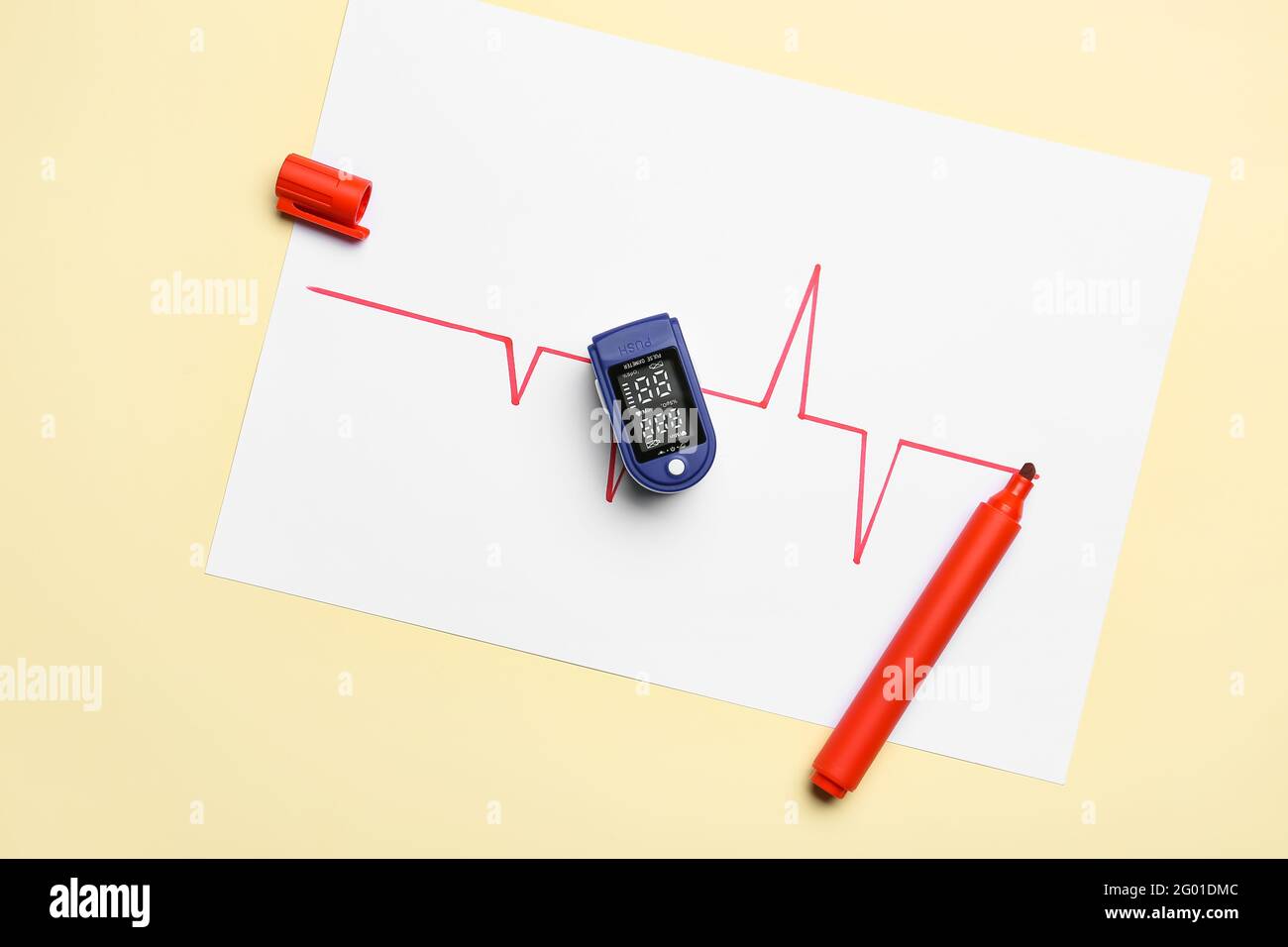 Pulse oximeter and paper sheet with drawn cardiogram on color ...