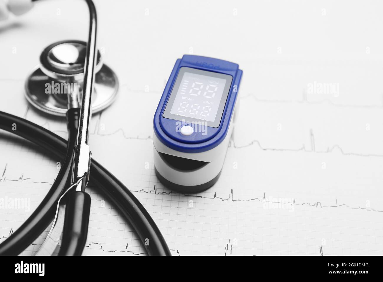 Pulse oximeter, stethoscope and cardiogram on white background Stock ...