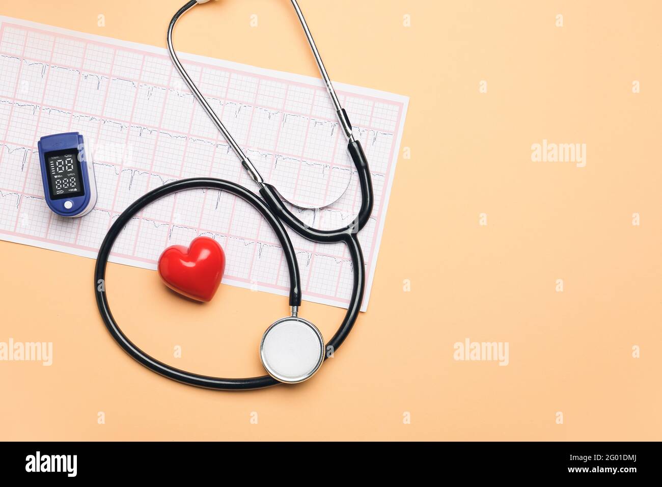 Red heart, pulse oximeter, stethoscope and cardiogram on color ...