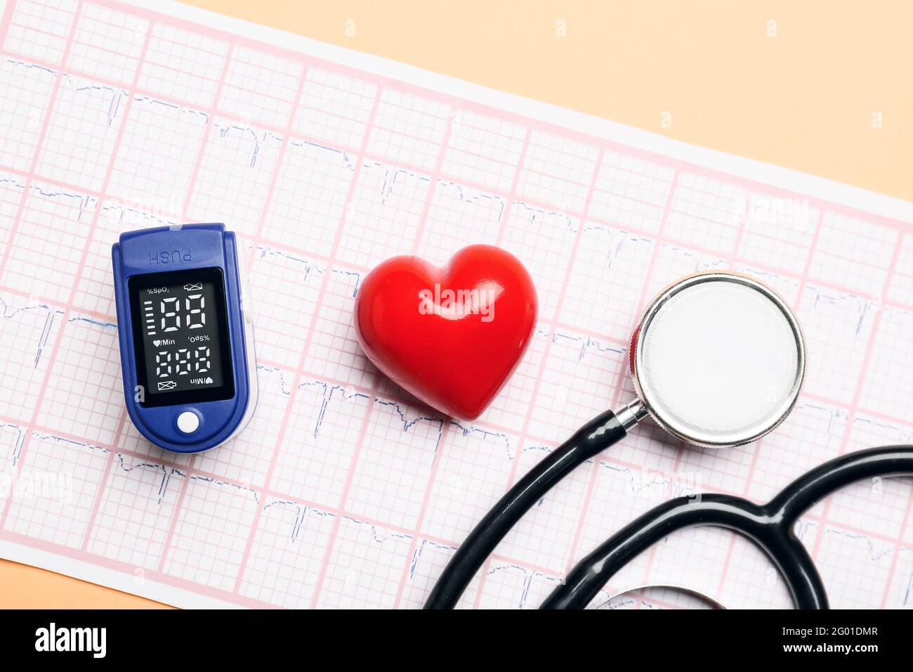 Red heart, pulse oximeter, stethoscope and cardiogram on color ...