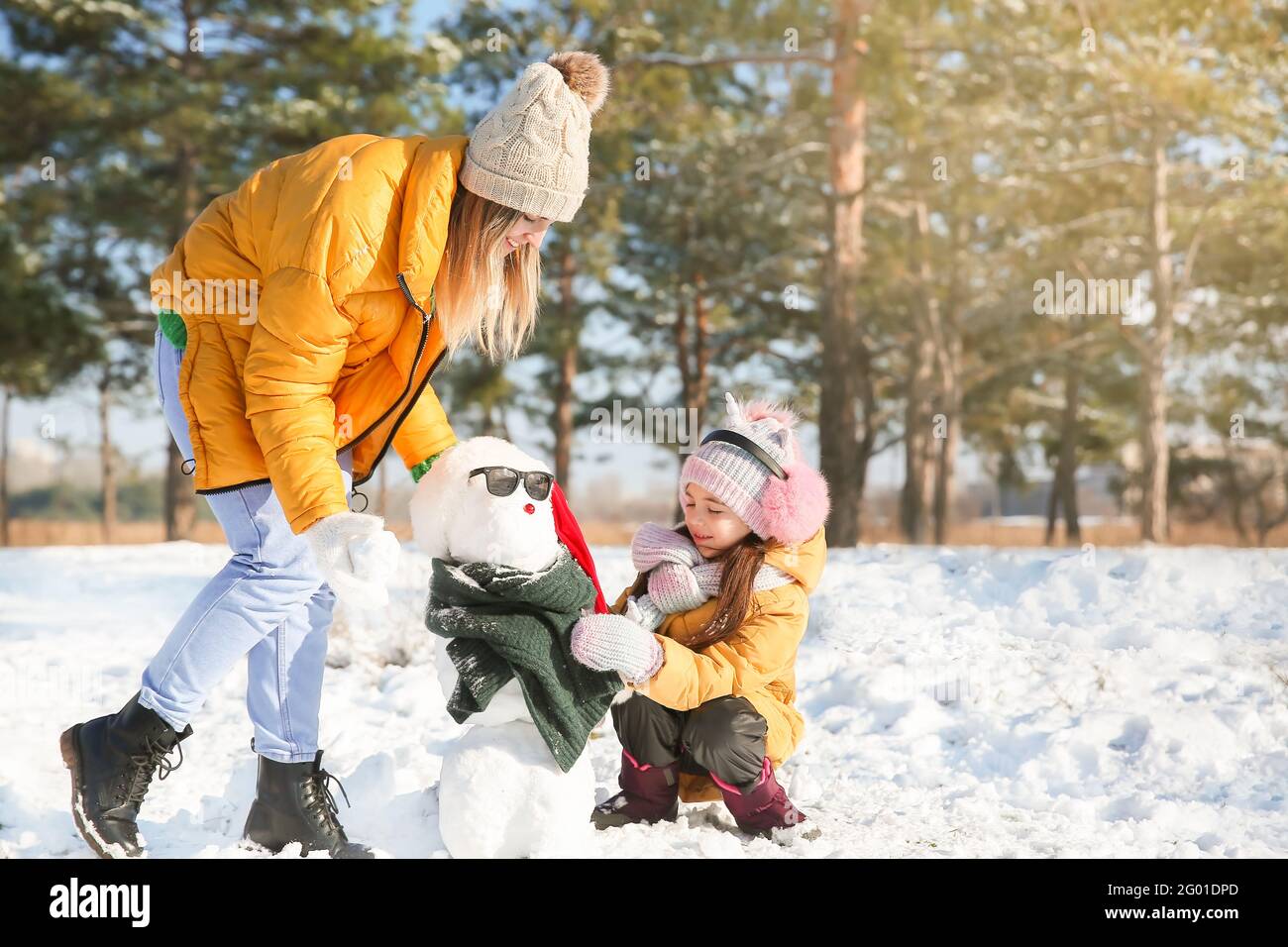 Happy family making snowman in park Stock Photo - Alamy