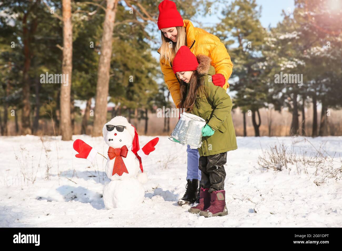 Happy family making snowman in park Stock Photo - Alamy