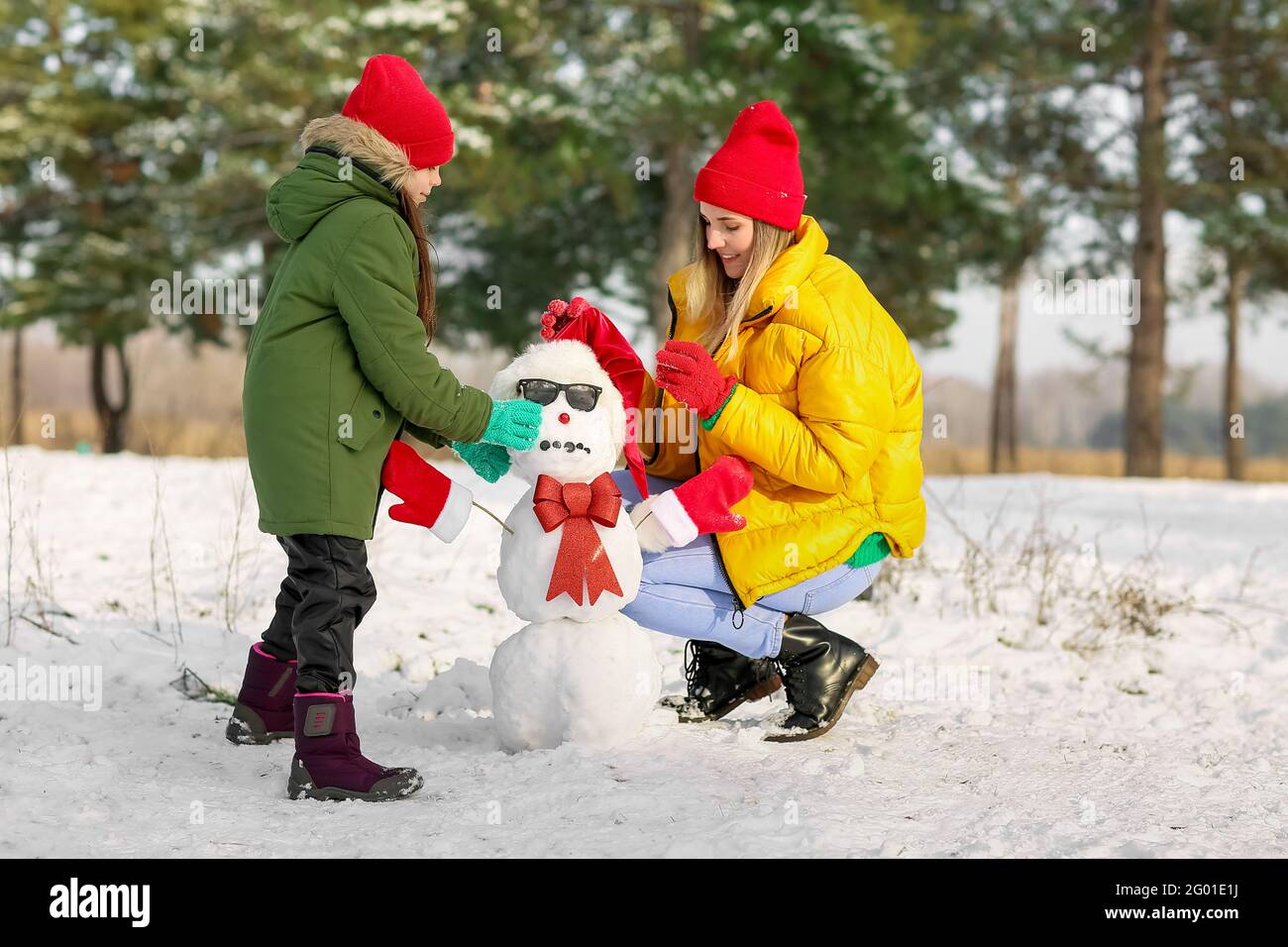 Happy family making snowman in park Stock Photo - Alamy