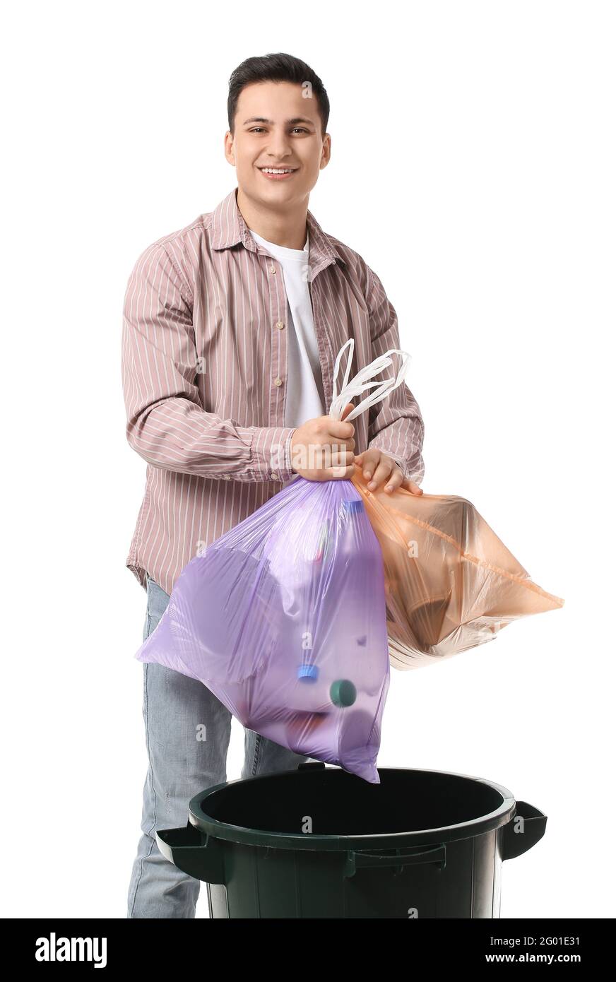 Young man throwing garbage in trash bin on white background Stock Photo ...