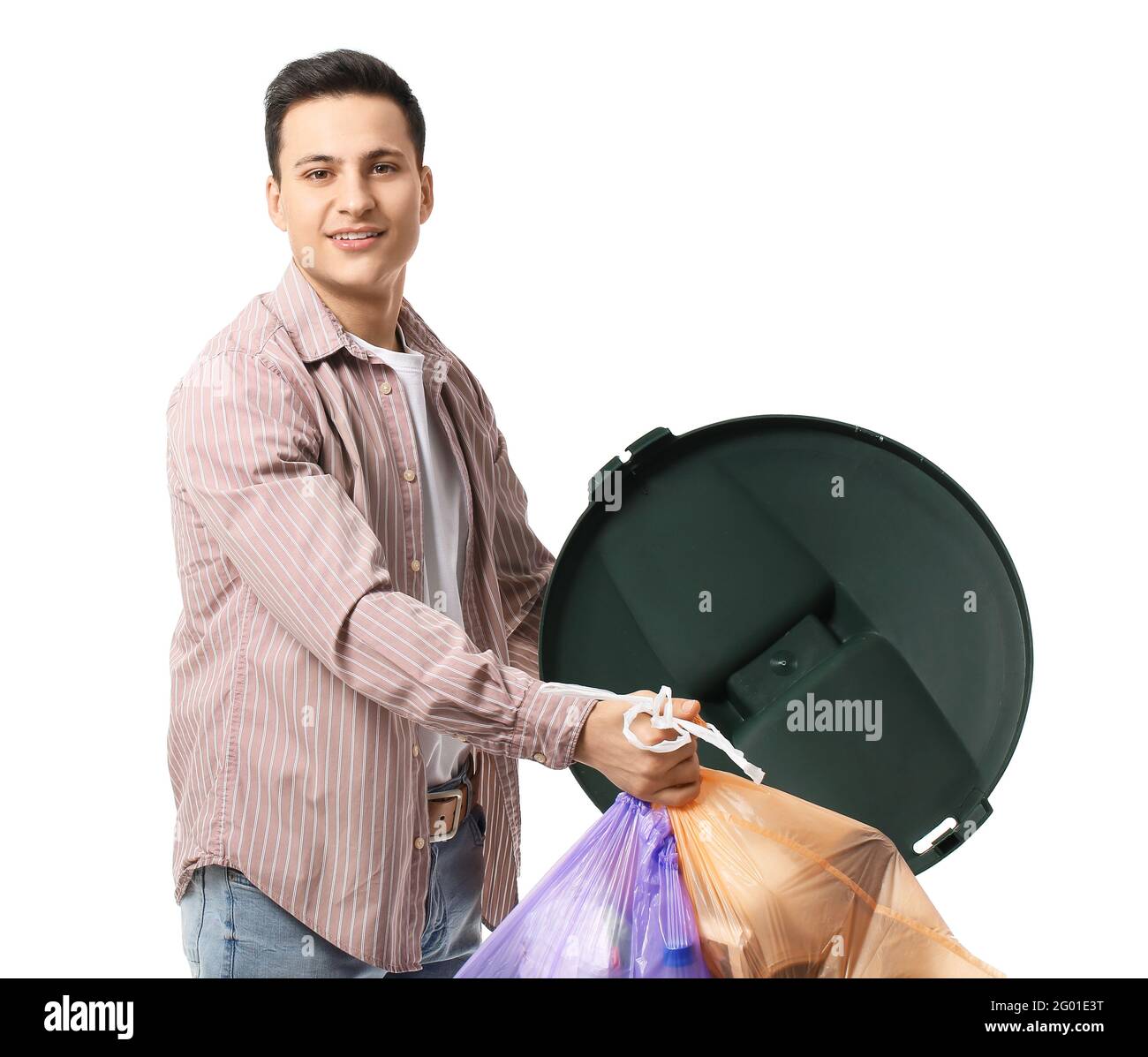 Young man throwing garbage in trash bin on white background Stock Photo ...