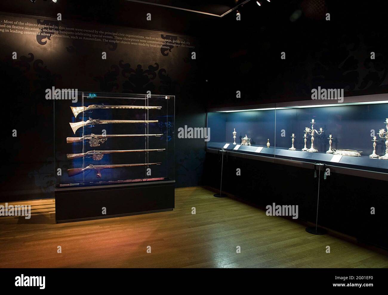 Showcase with guns and a showcase with silverware including two ...
