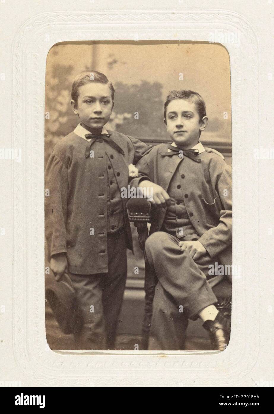 Studio portrait of a two boys in the same clothing Stock Photo - Alamy