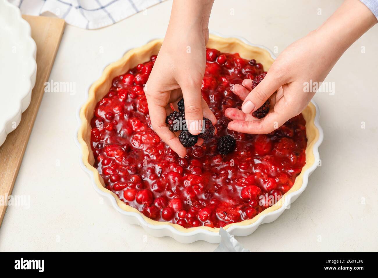 Woman cooking berry pie in kitchen Stock Photo - Alamy