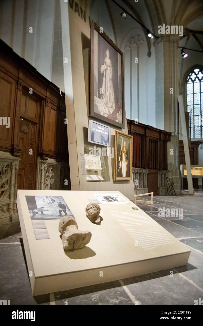 Church interior with a slanted panel on which two sculpted heads lie ...
