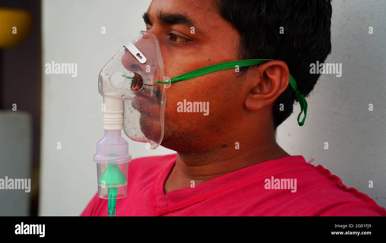 A Indian man with Oxygen mask on the face at home during lockdown in ...
