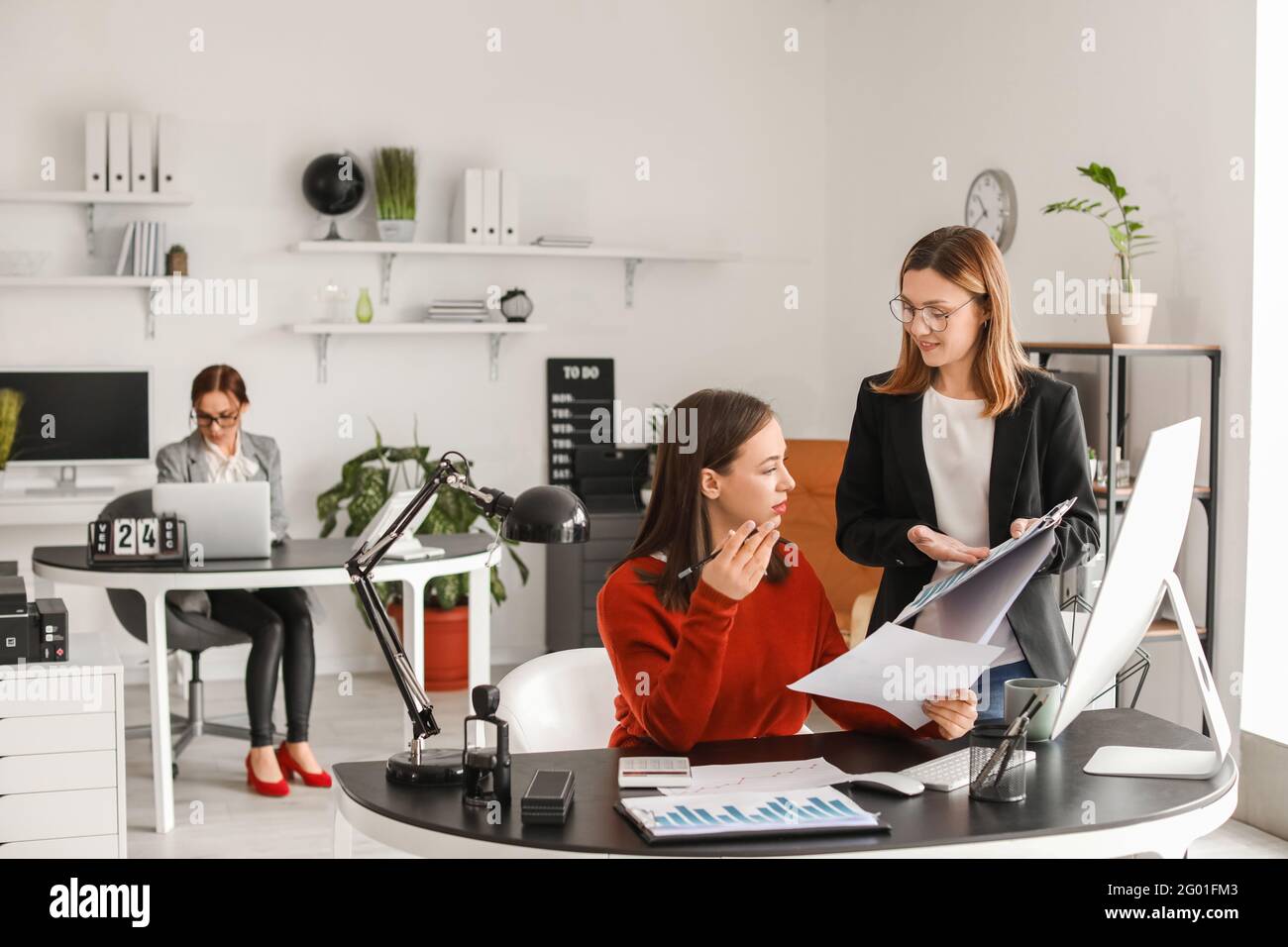 Female accountants working in office Stock Photo - Alamy