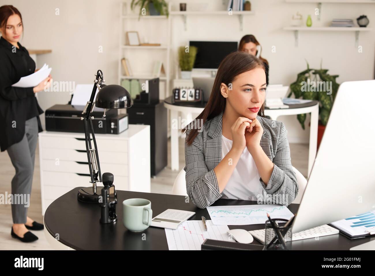Female accountant working in office Stock Photo - Alamy