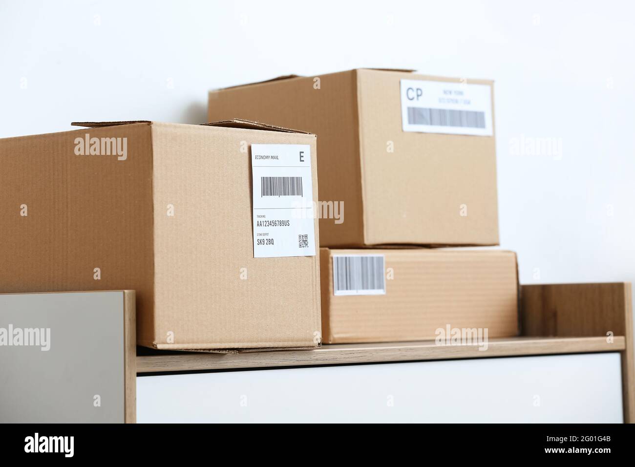Parcel boxes on shelf at home Stock Photo - Alamy