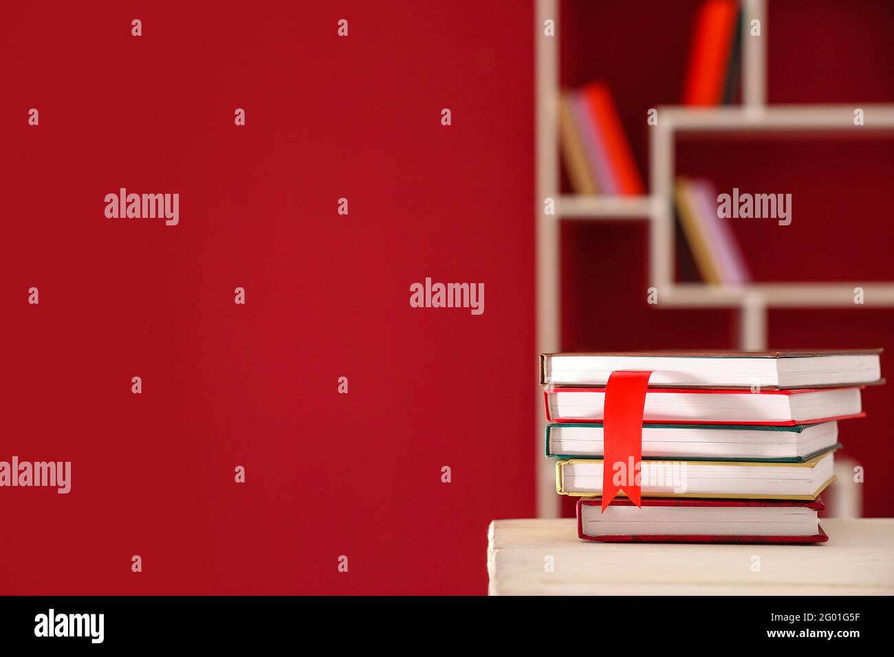 Books with bookmark on color background Stock Photo - Alamy