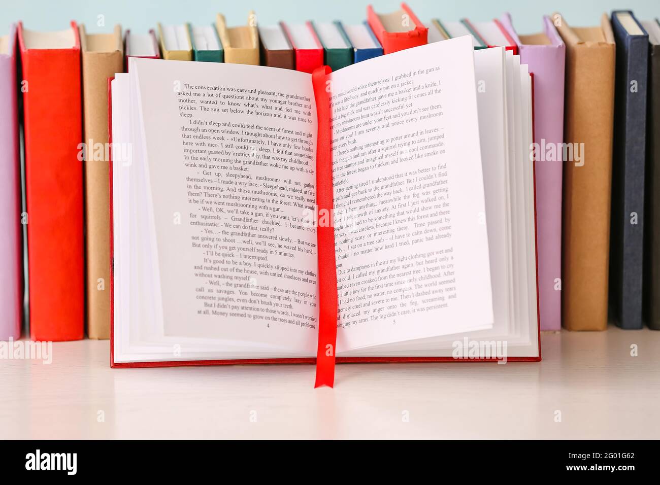 Open book with bookmark on color background Stock Photo - Alamy