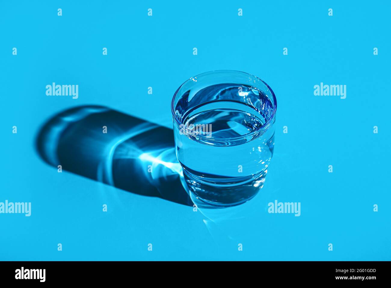 Glass of water on color background Stock Photo - Alamy