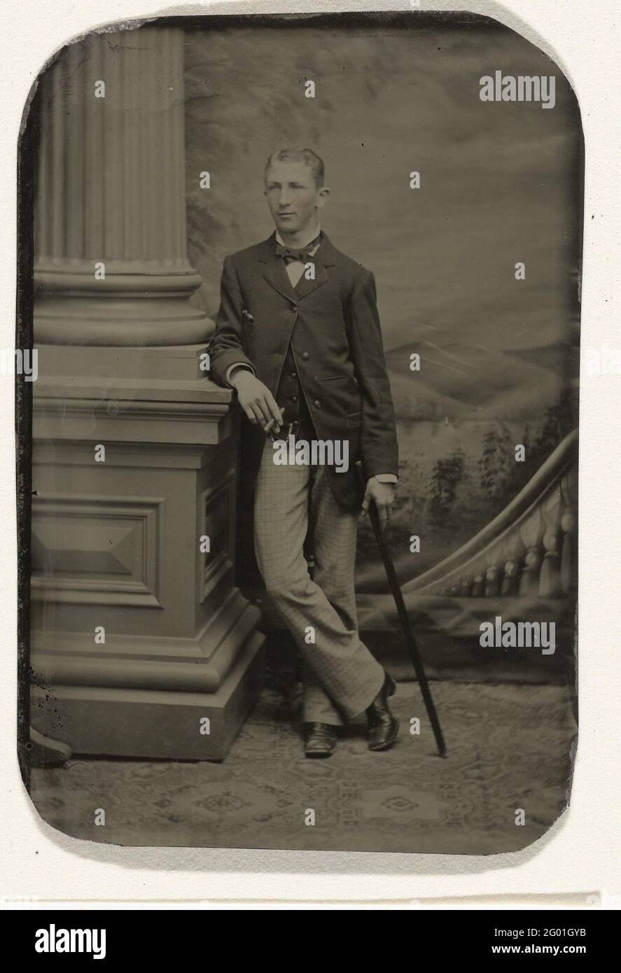 Portrait of a man standing at a column and in front of a painted ...