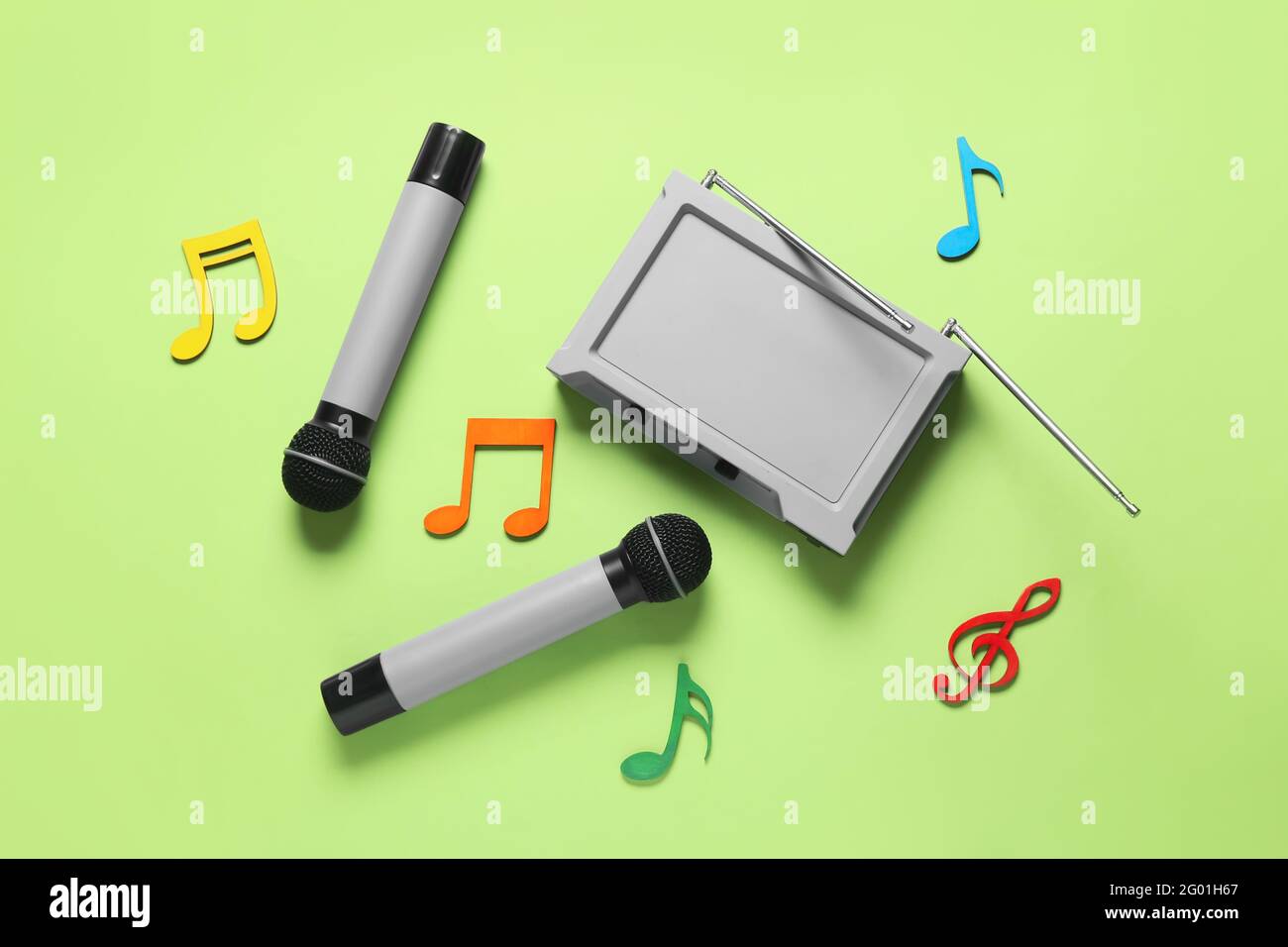 Modern microphones with audio system and music notes on color ...