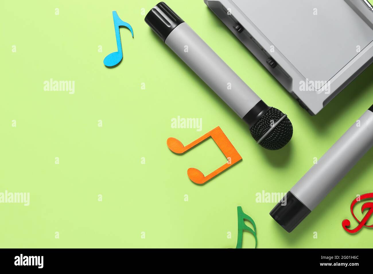 Modern microphones with audio system and music notes on color ...